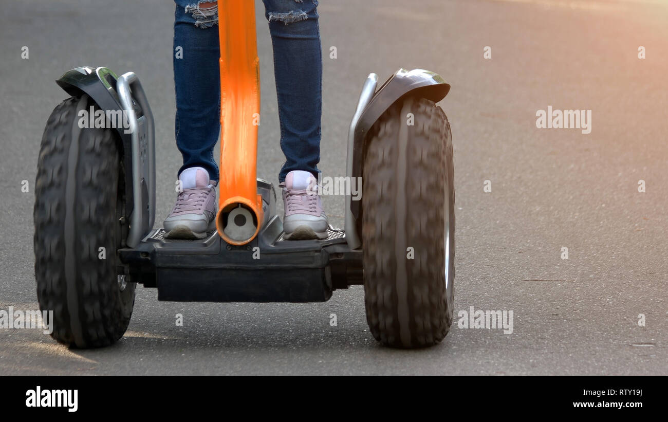 Teenage girl driving on segway outdoors. Faceless girl enjoying riding ...