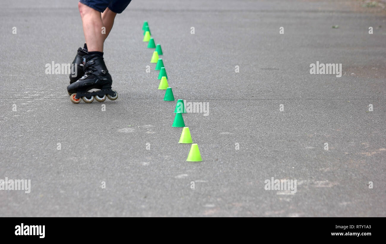Boy rollerblading on asphalt road. Teenage roller practicing tricks ...