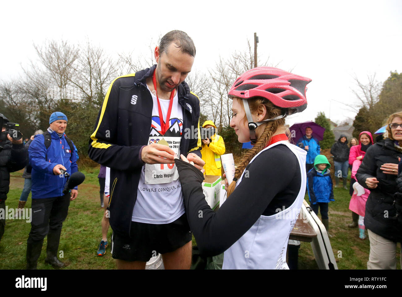 Christopher Hepworth slides an engagement ring on his partner Tanisha ...