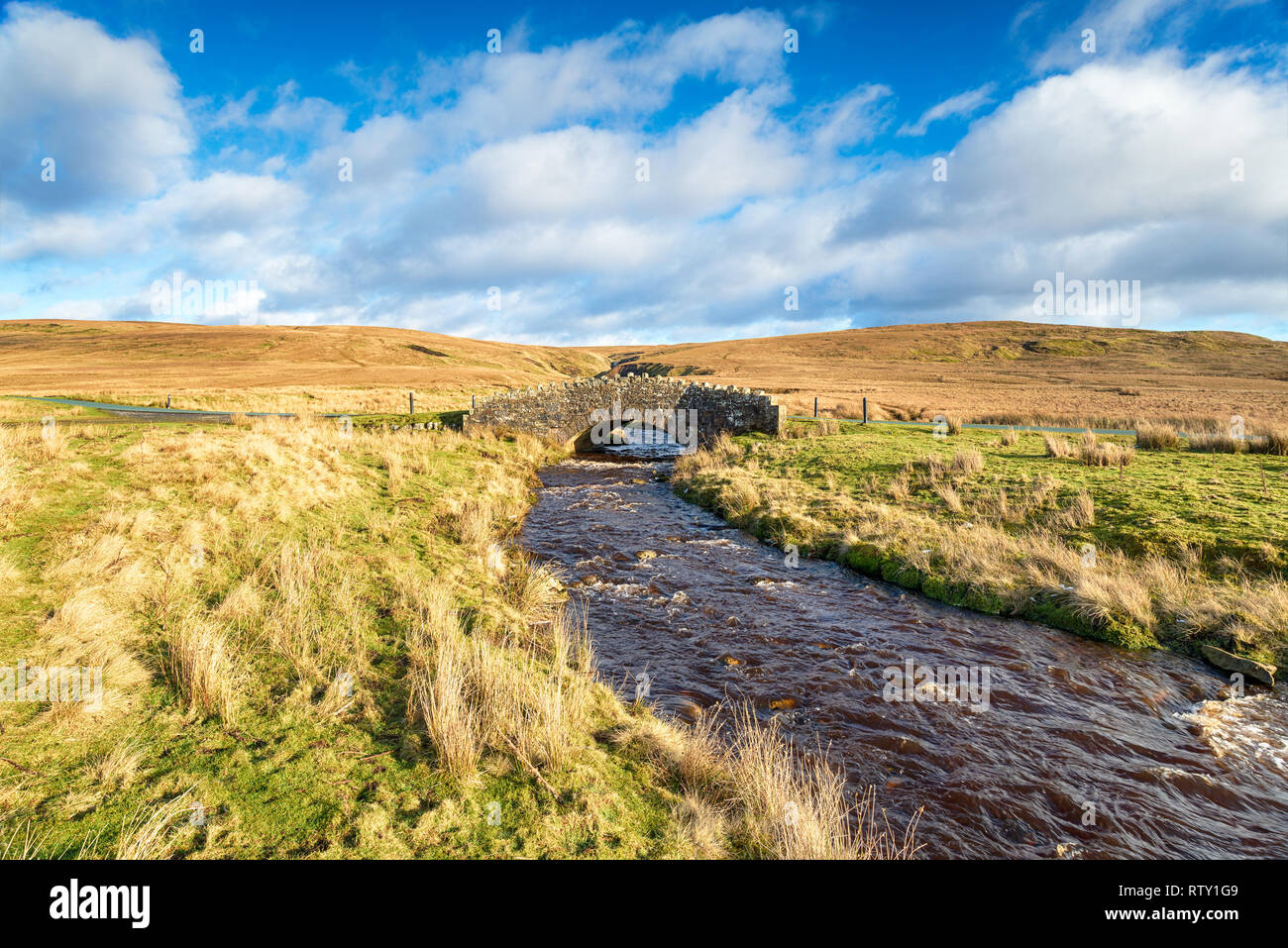 A stone bridge over the Arkle Beck on the Pennine Way as it crosses Tan ...