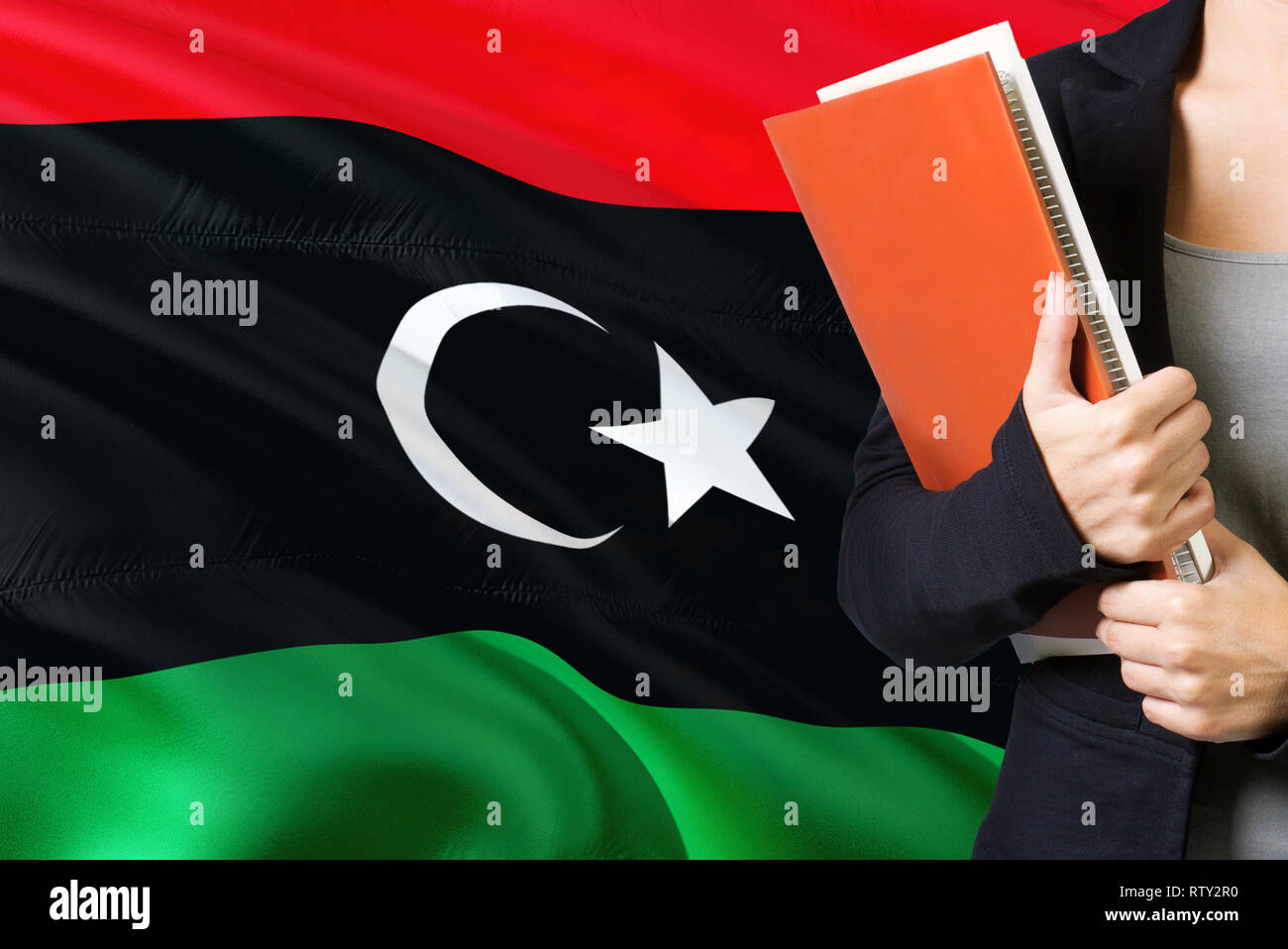 Learning Libyan language concept. Young woman standing with the Libya ...