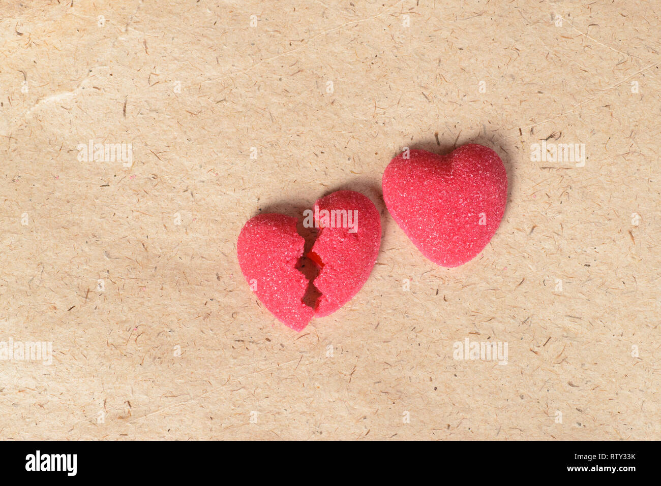 Broken candy heart on paper Stock Photo - Alamy