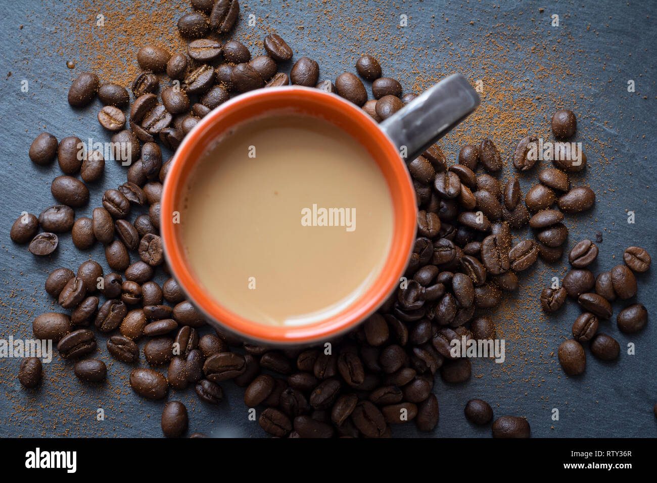 Mug of coffee and scattered coffee beans hi-res stock photography and ...