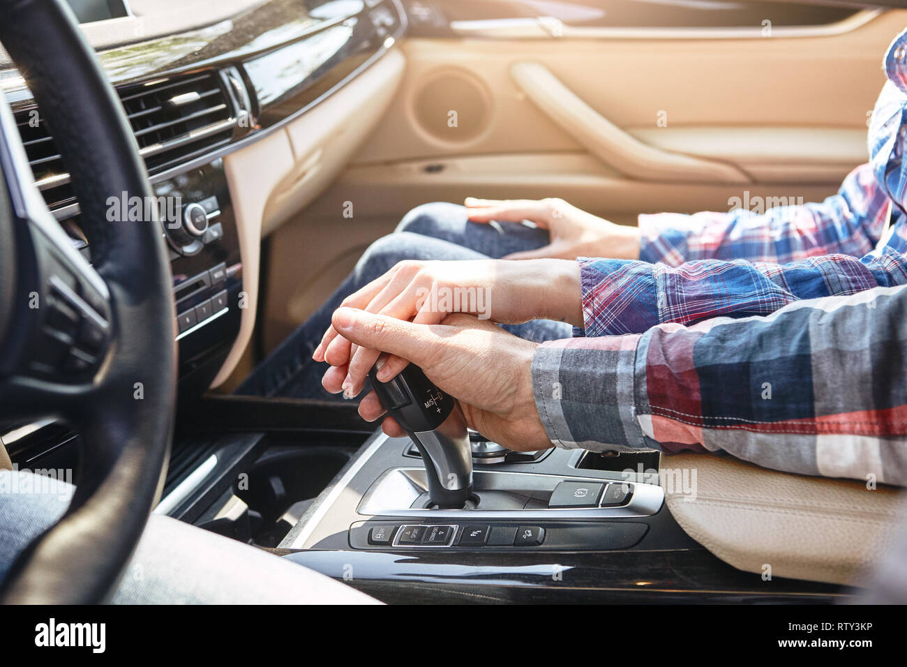 Young man change speed, shifting gears holding hand on gearbox together ...