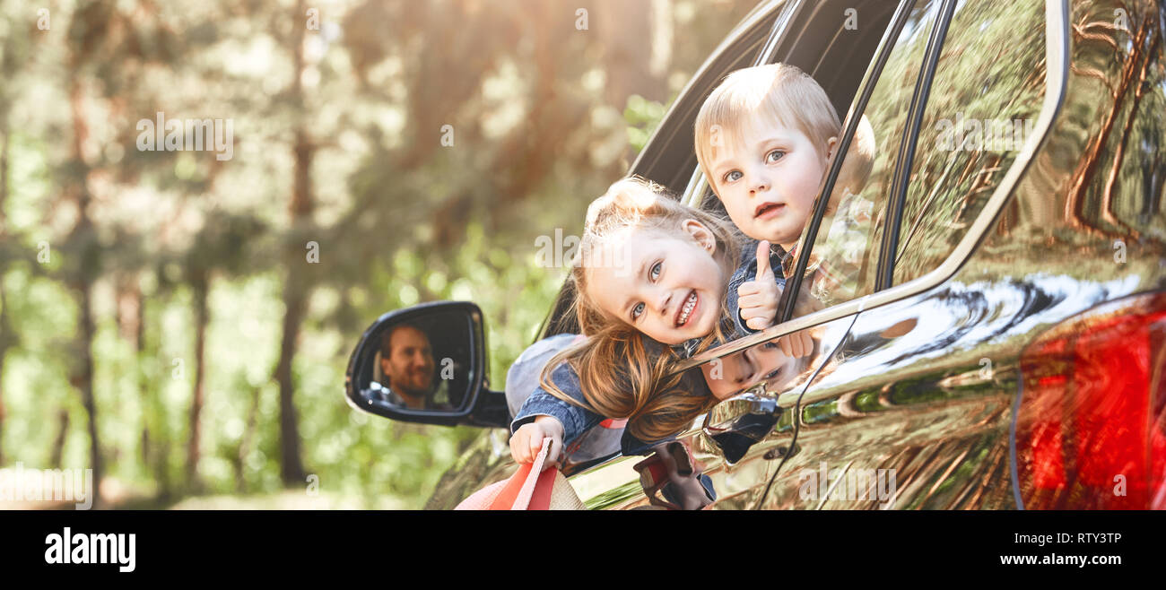 Blond caucasian children, boy and girl looking out the window while ...