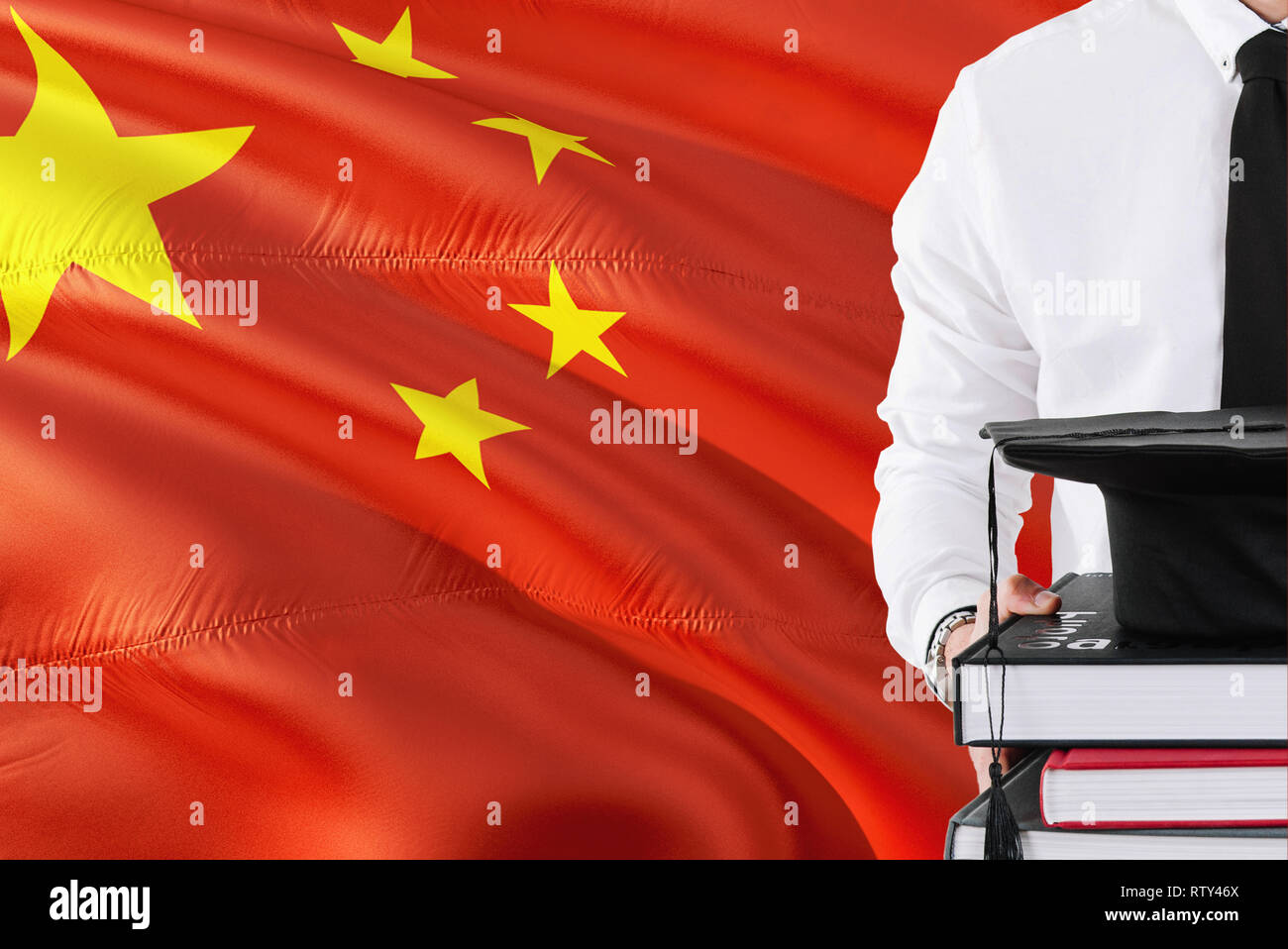 Successful Chinese student education concept. Holding books and ...