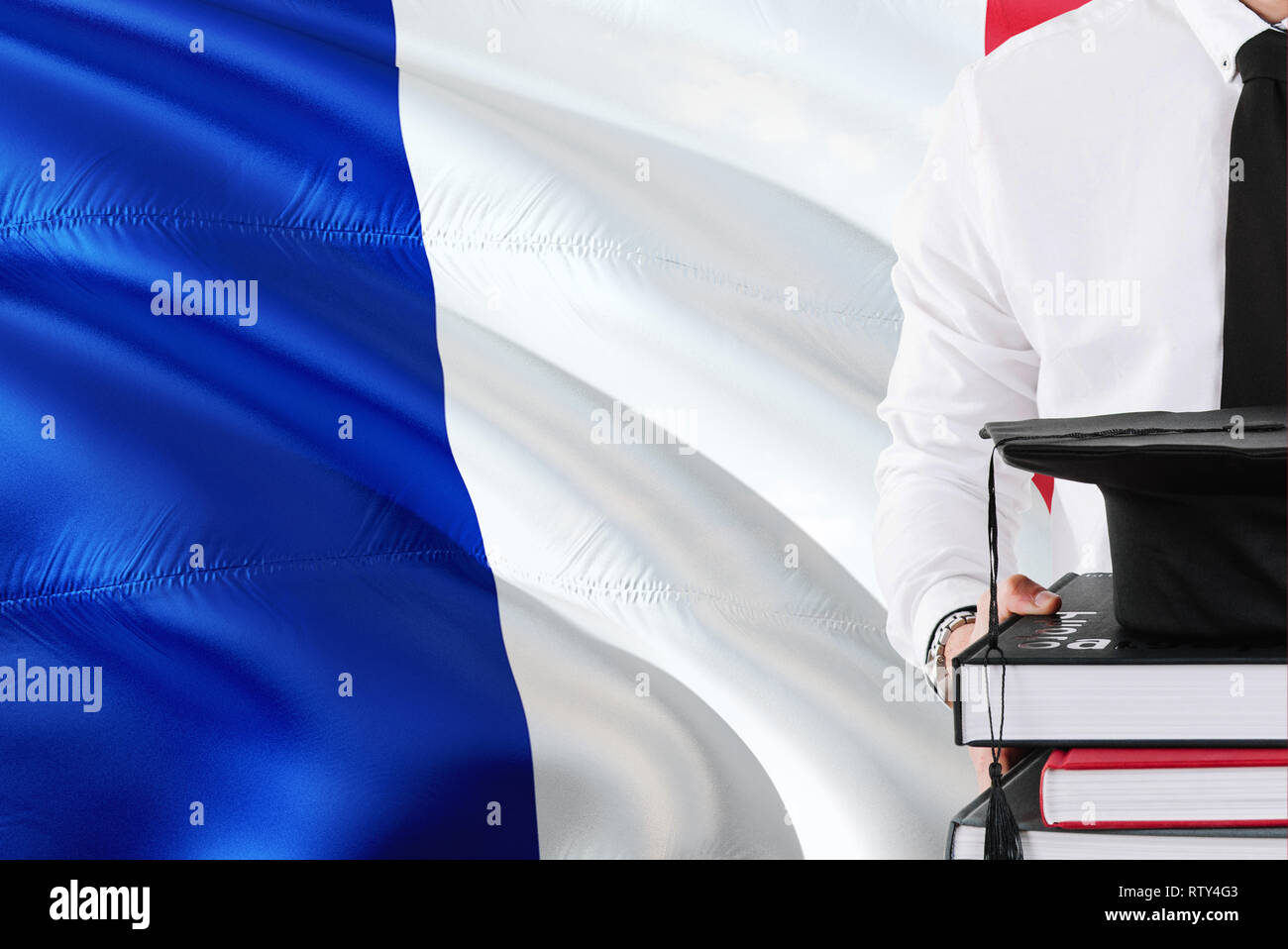 Successful French student education concept. Holding books and ...