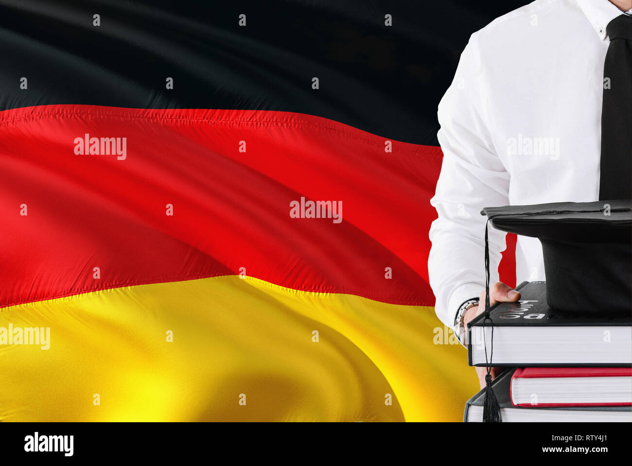 Successful German student education concept. Holding books and ...