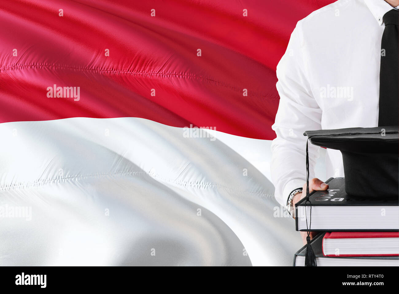 Successful Indonesian student education concept. Holding books and ...