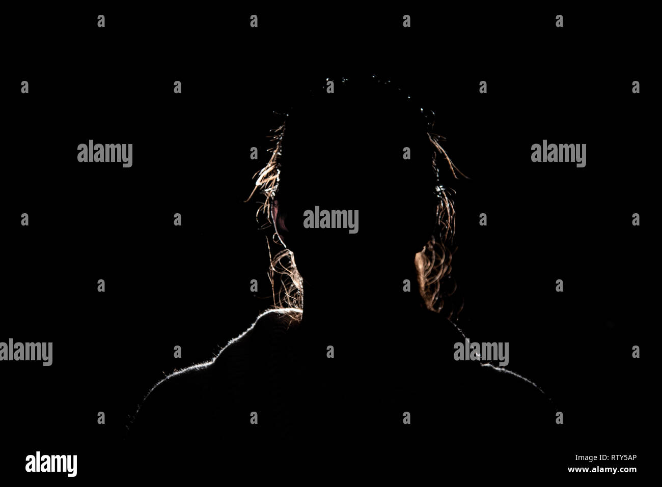Woman backlighted over a black background Stock Photo - Alamy