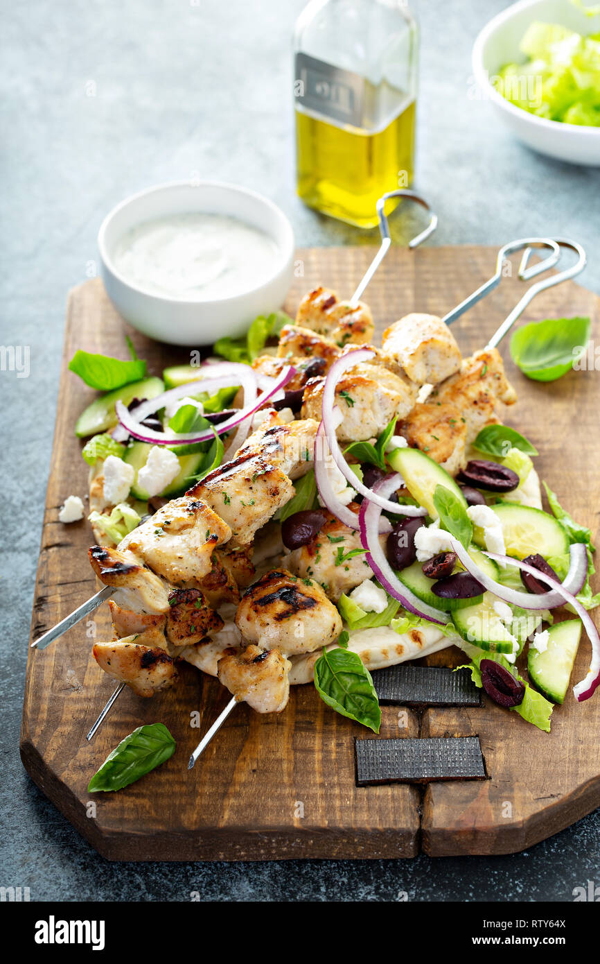 Chicken kebabs on a pita with vegetables and olives, greek inspired ...