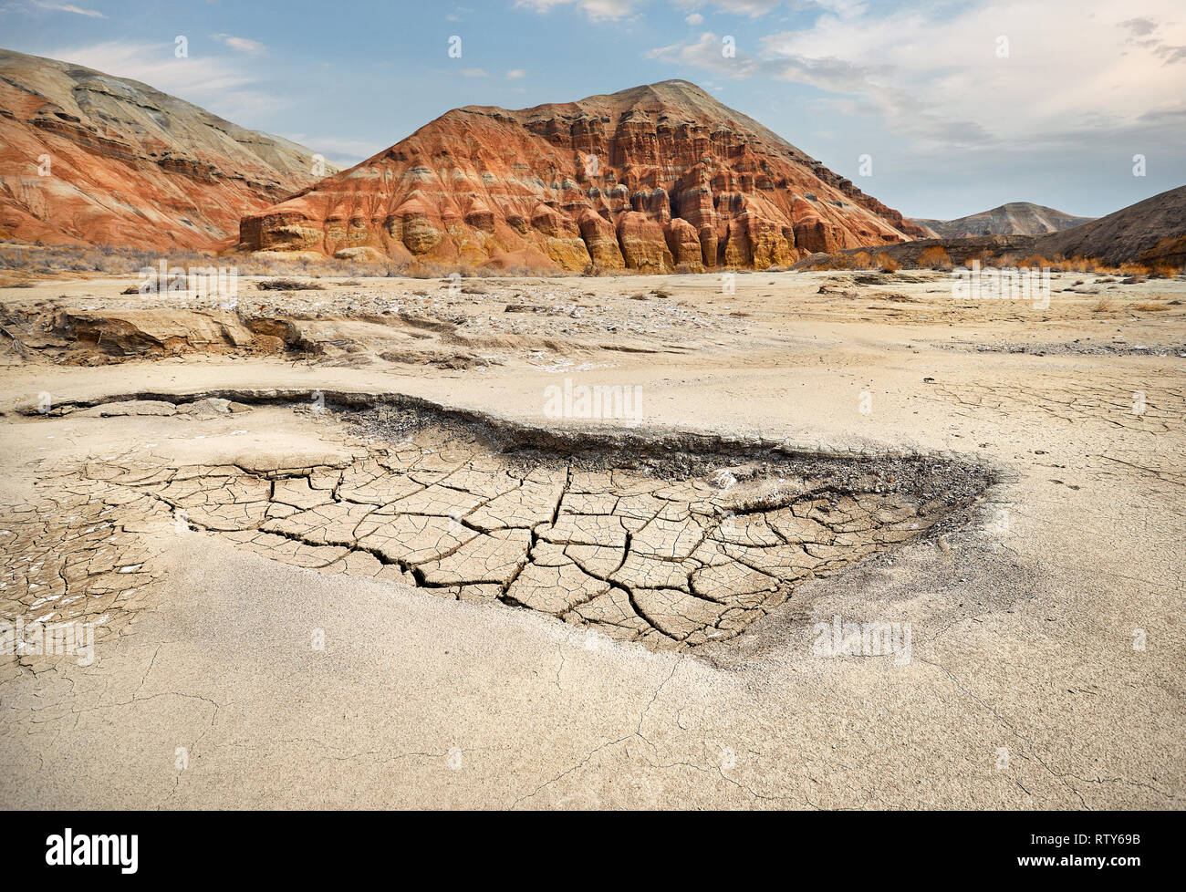 Red Mountains and cracked dry earth in the desert of Kazakhstan Stock ...