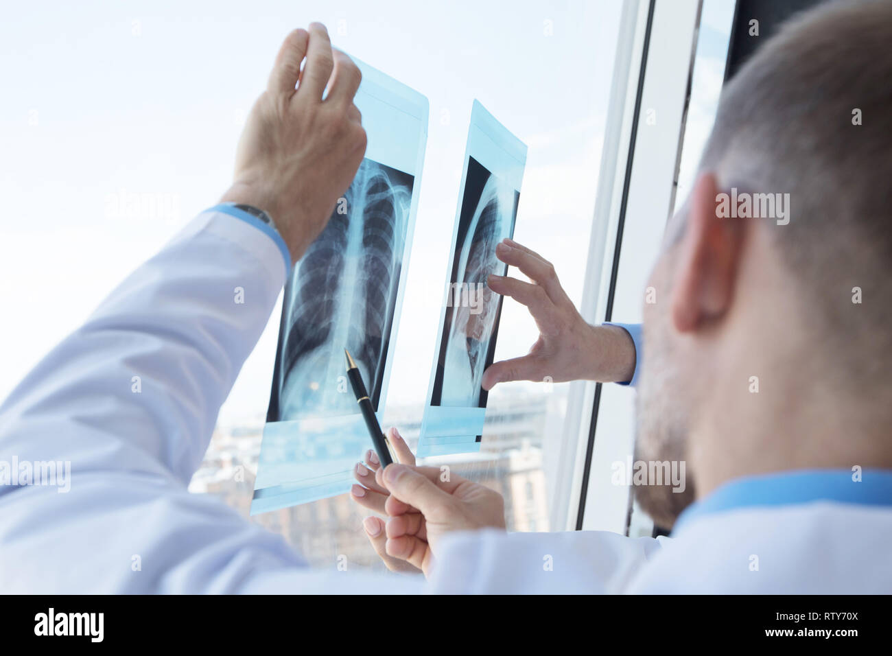 Group of doctors look and discuss x-ray in a clinic or hospital Stock ...