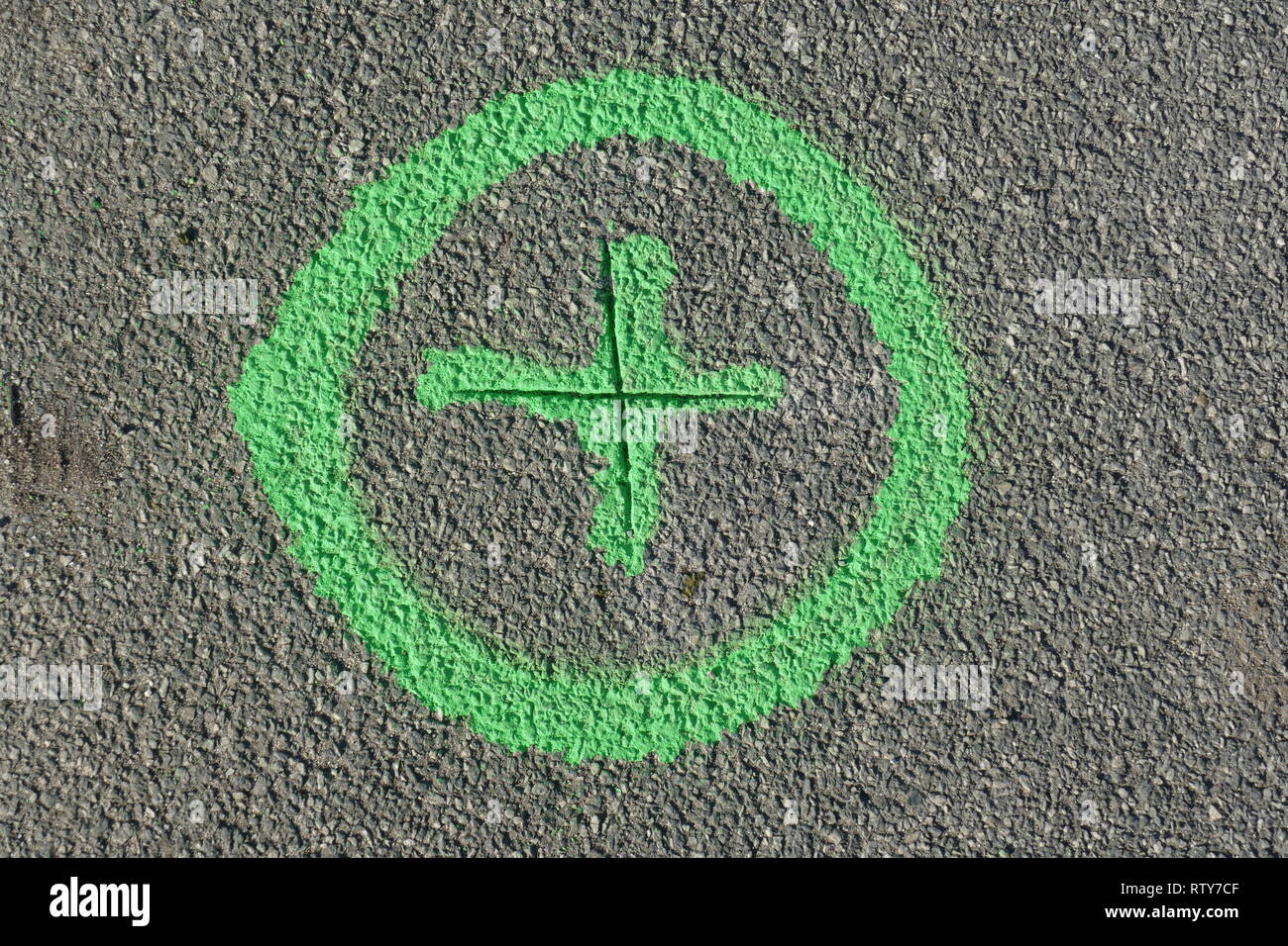 Ground mark green cross and circle on the asphalt Stock Photo - Alamy
