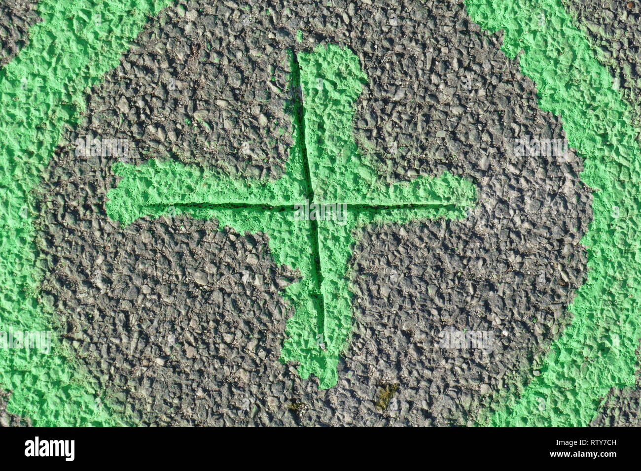 Ground mark green cross and circle on the asphalt Stock Photo - Alamy