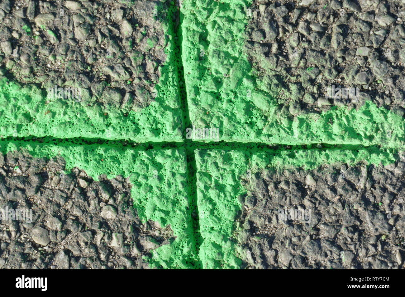 Ground mark green cross on the asphalt Stock Photo - Alamy