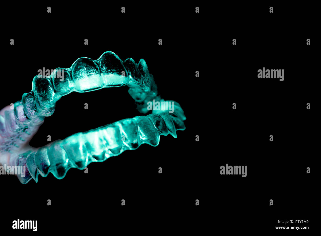 Woman hand holding denture alignment retainer Stock Photo - Alamy