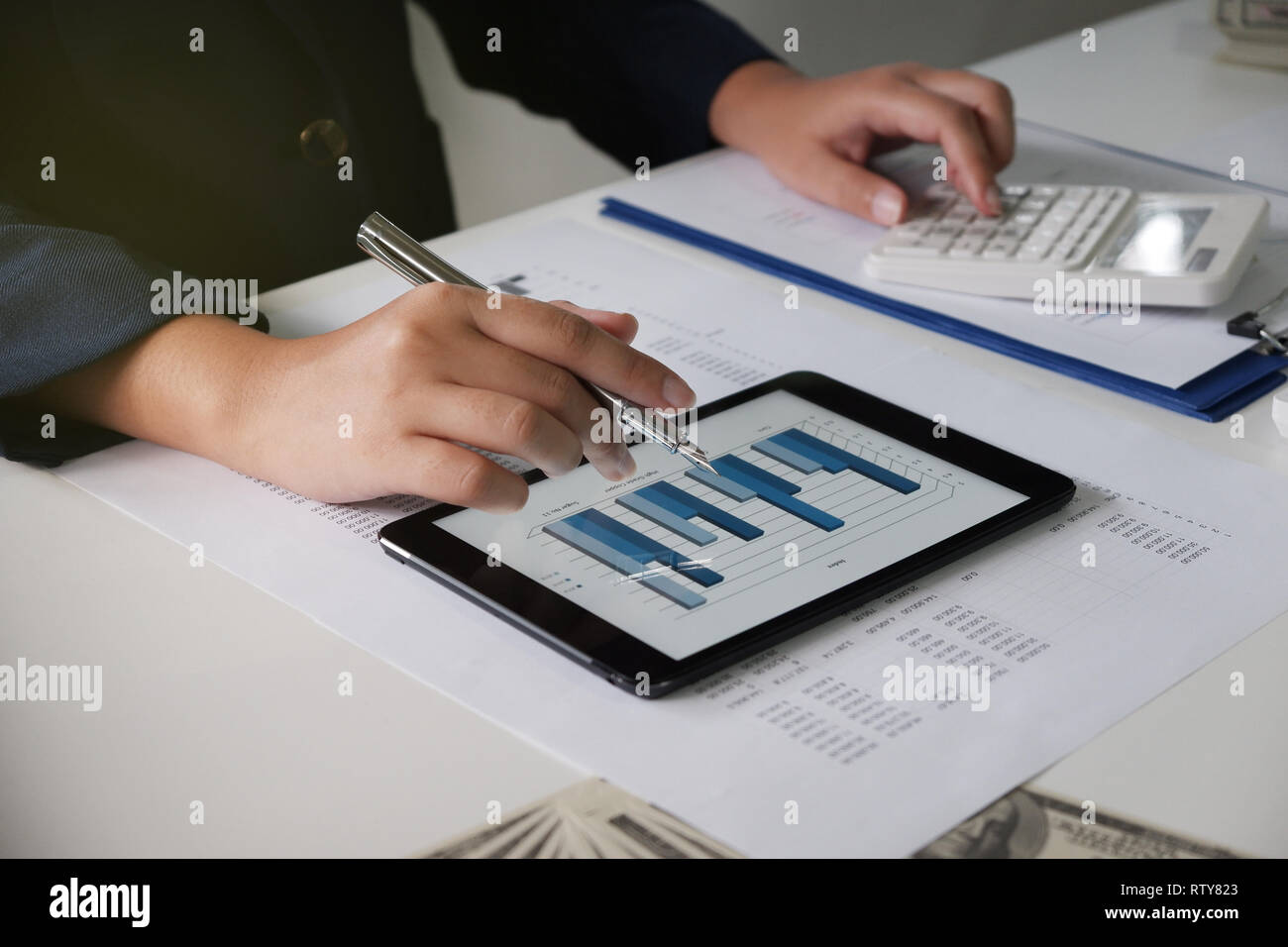 Women working in office. financial analysis with charts on pad for ...