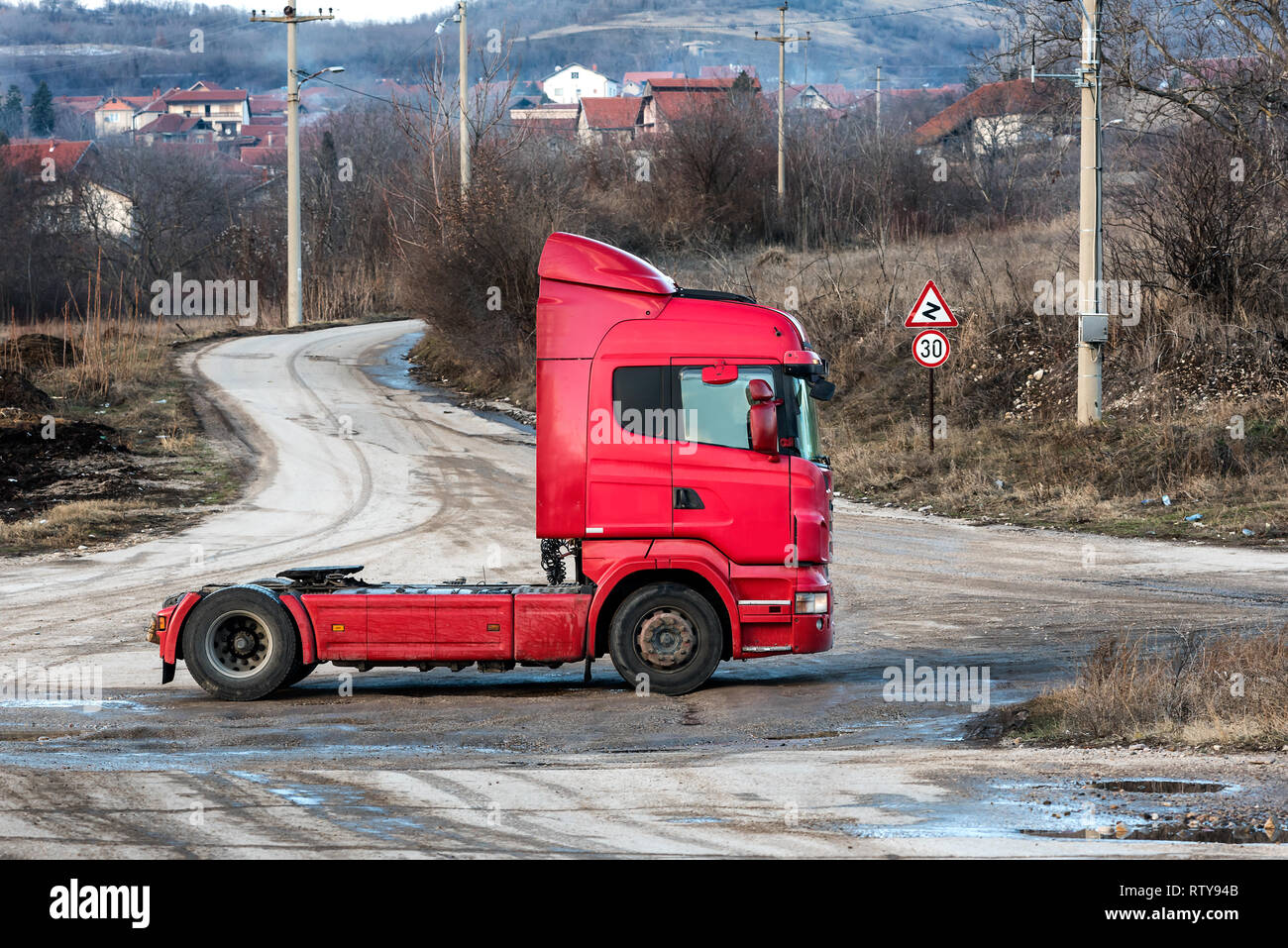 Red Semi Truck on a dirty rural country road intersection Stock Photo ...