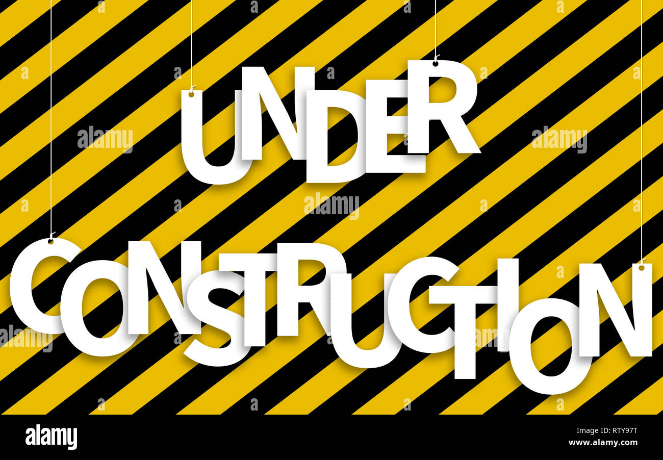 Under Construction text hanging on ropes on a yellow and black ...