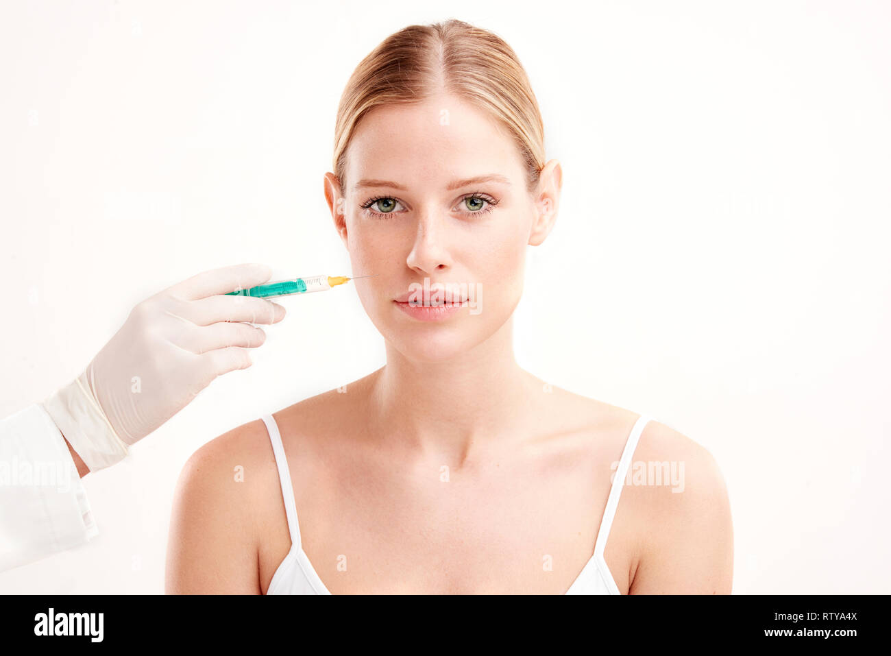 Close-up portrait shot of beautiful young woman having botox on her ...