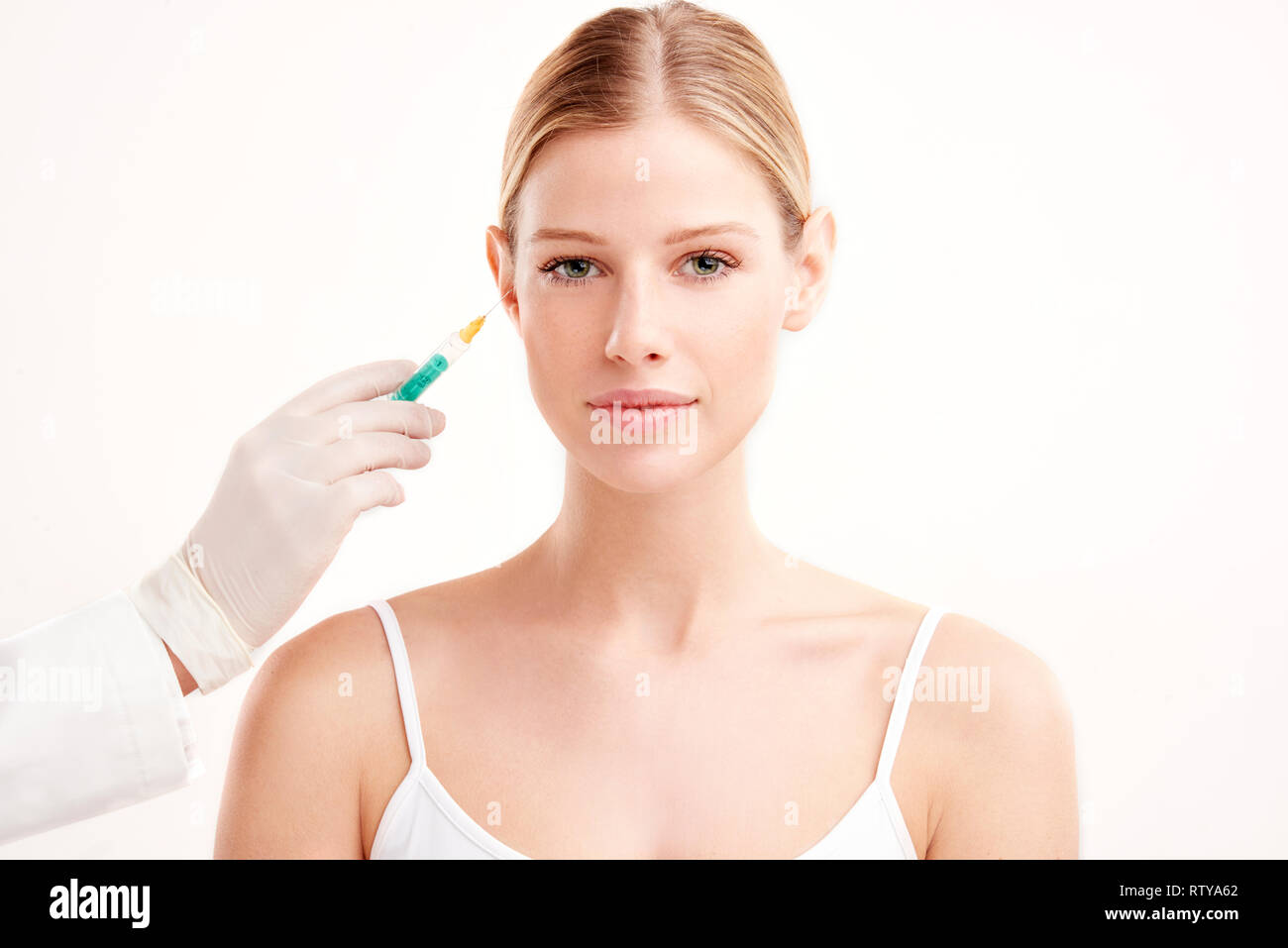 Close-up portrait shot of beautiful young woman having botox on her ...