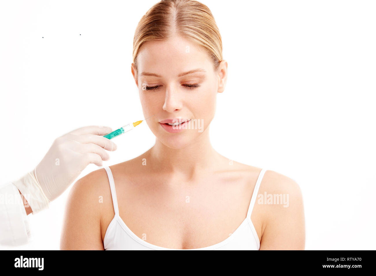 Close-up portrait shot of beautiful young woman having botox on her ...