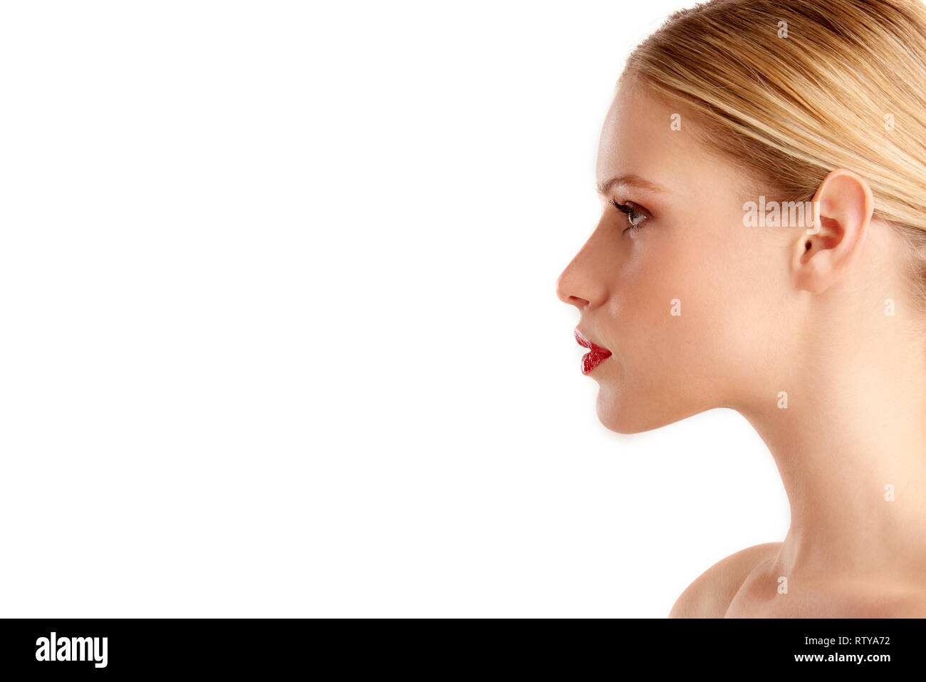Close-up profile face portrait of a beautiful young woman posing at ...
