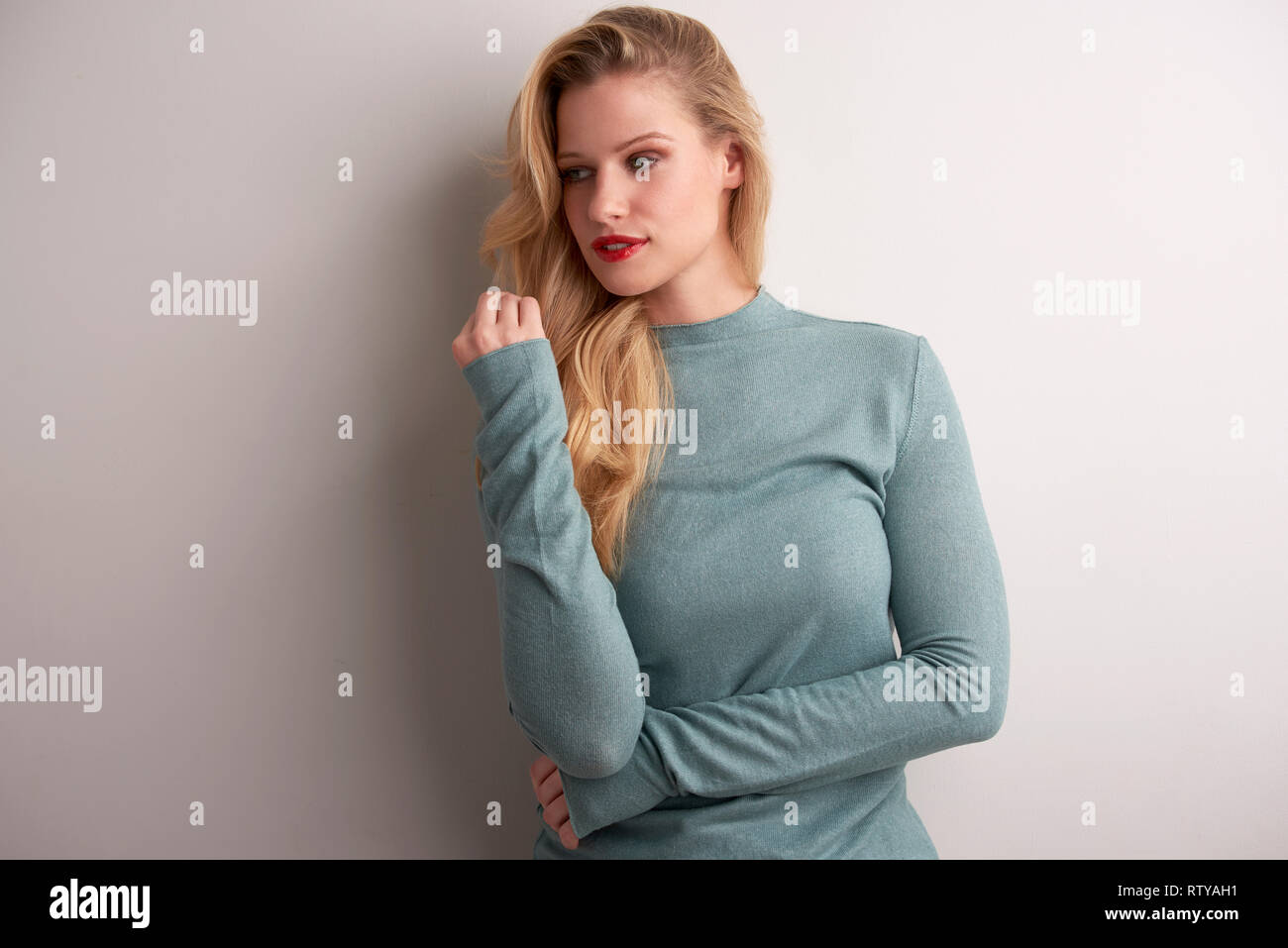 Half profile shot of beautiful young woman with blond long hair ...