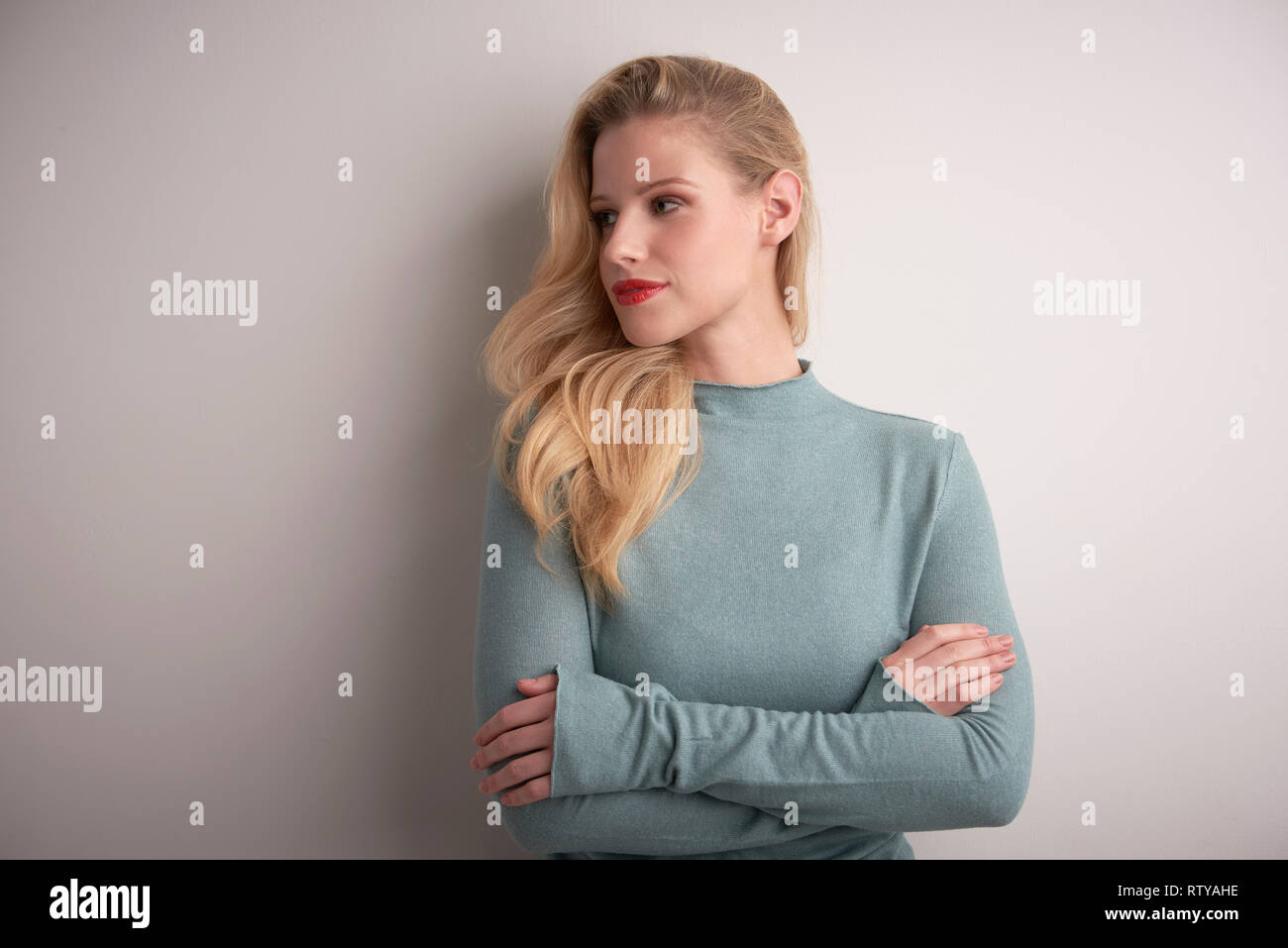 Half profile shot of beautiful young woman with blond long hair ...