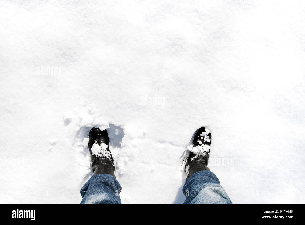 Feet in leather boots in deep snow on sunny winter weather Stock Photo ...