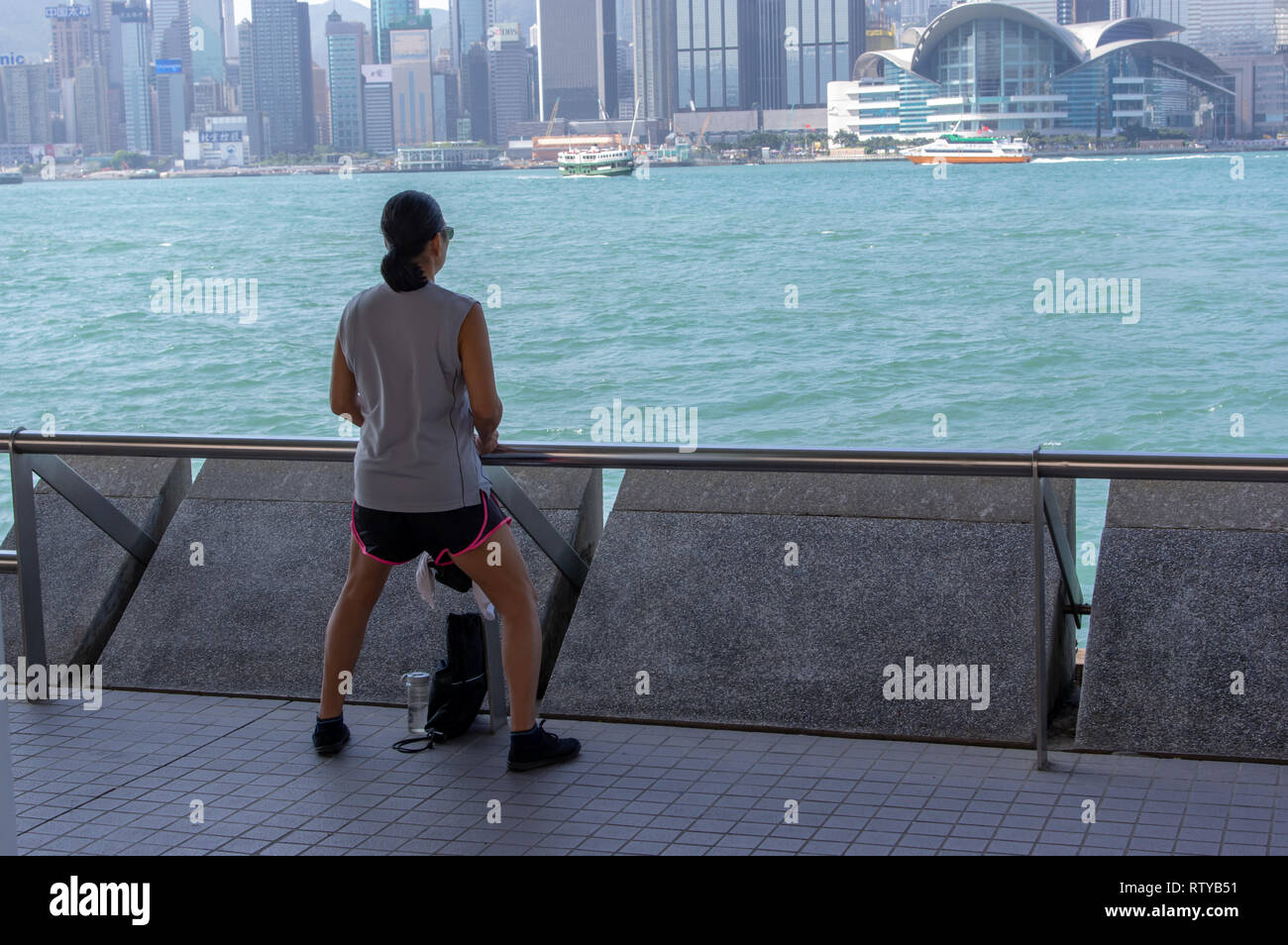 Exercising on the promenade at Hong Kong harbor Stock Photo - Alamy