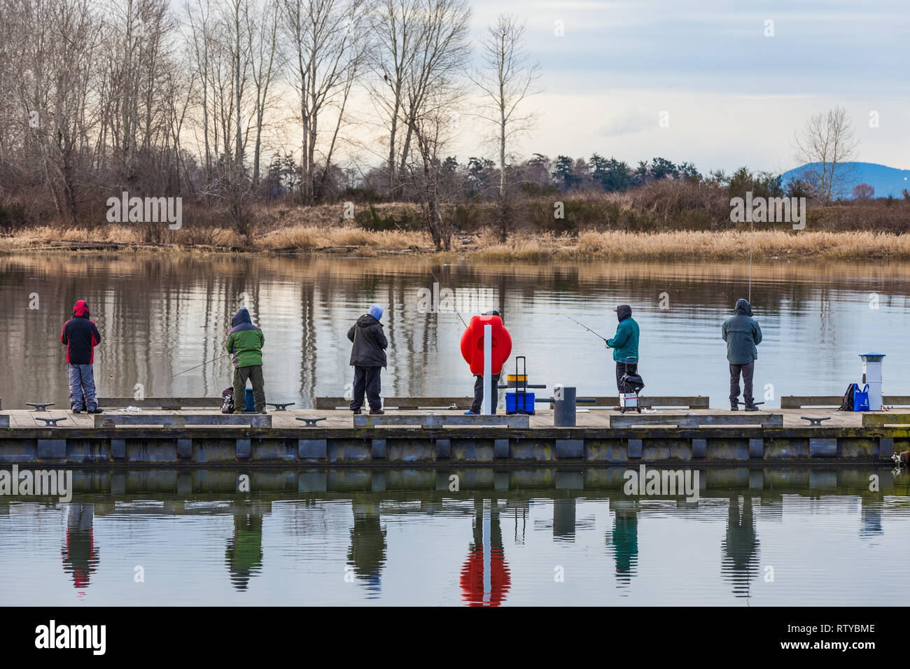 Group of people fishing from a floating pontoon in Steveston British ...