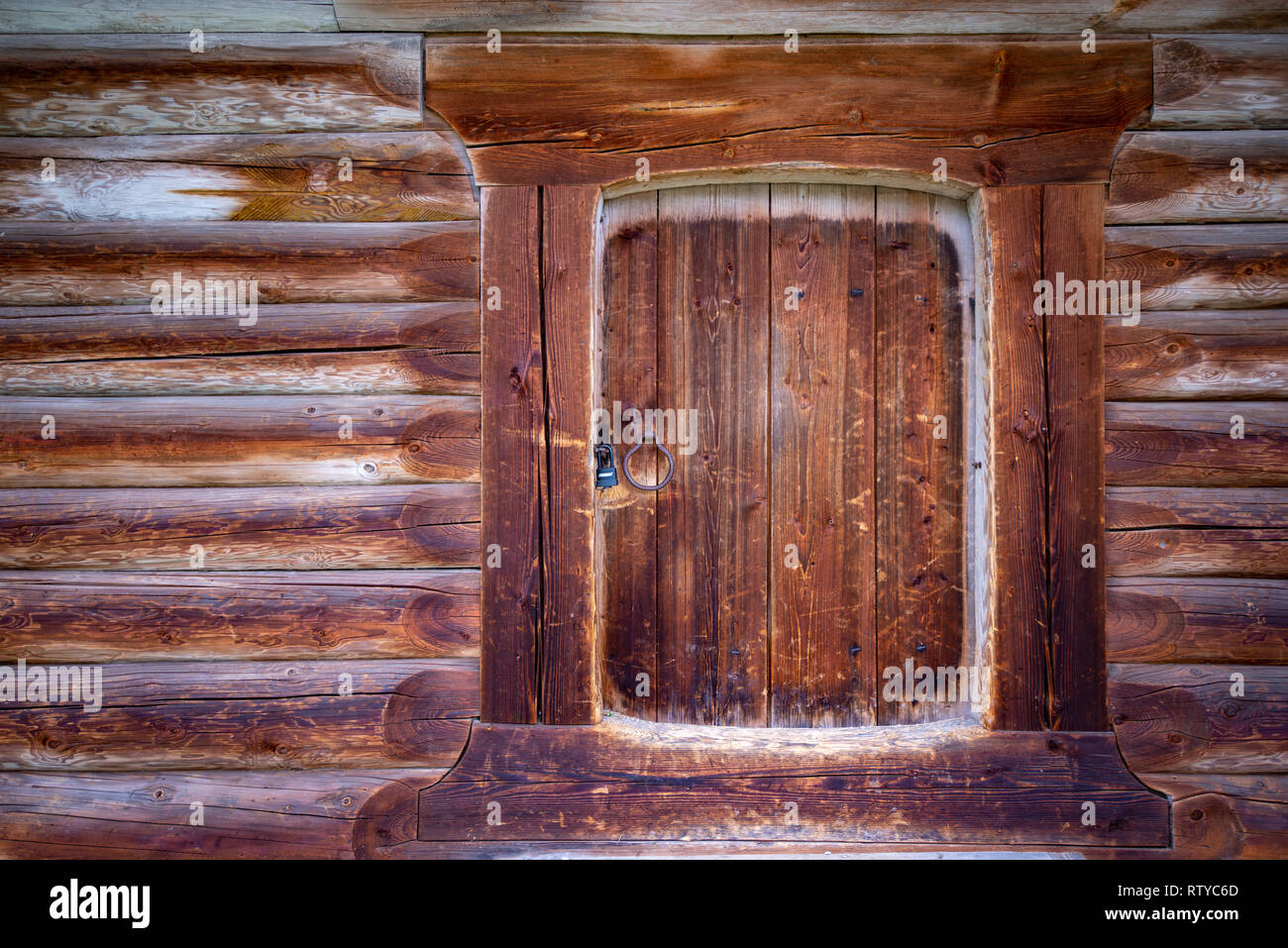 Old wood log background with cracks and lines. Door in the middle. Wall ...