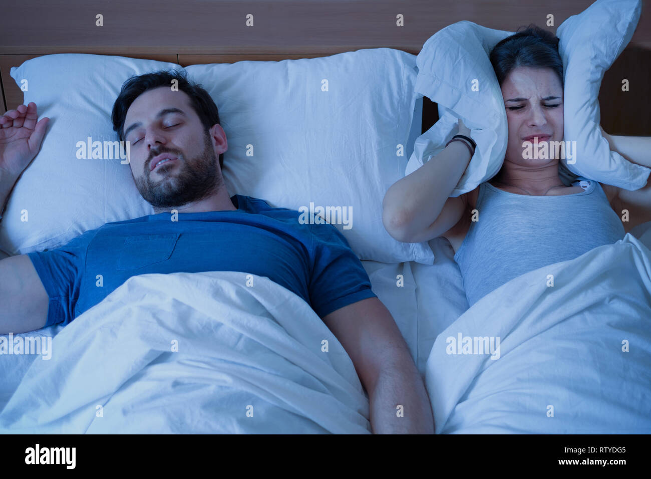 Man snoring in the bed because of night apnoea sleep disorder Stock ...