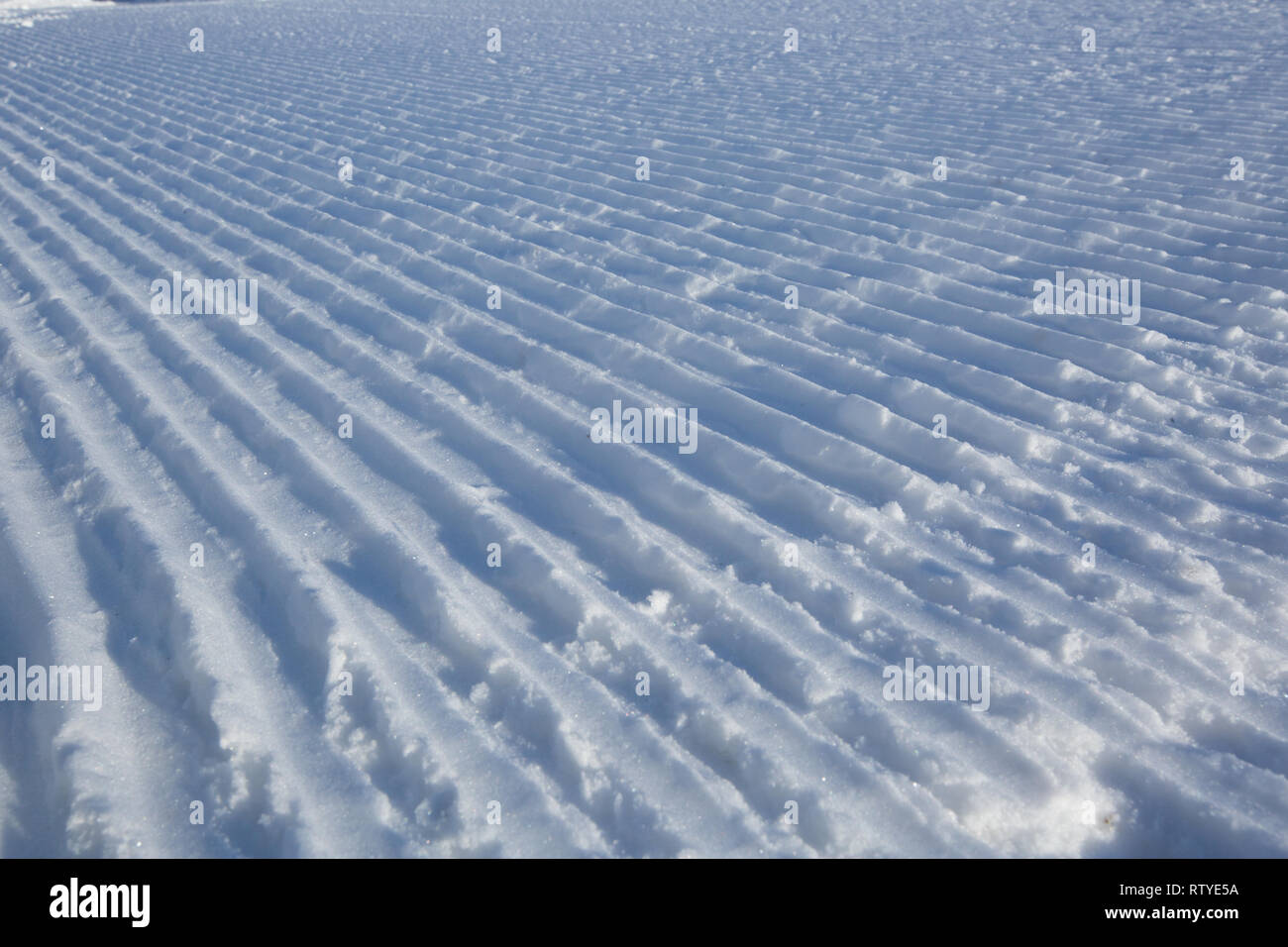 Snow lines made from a snow machine on a ski slope Stock Photo - Alamy