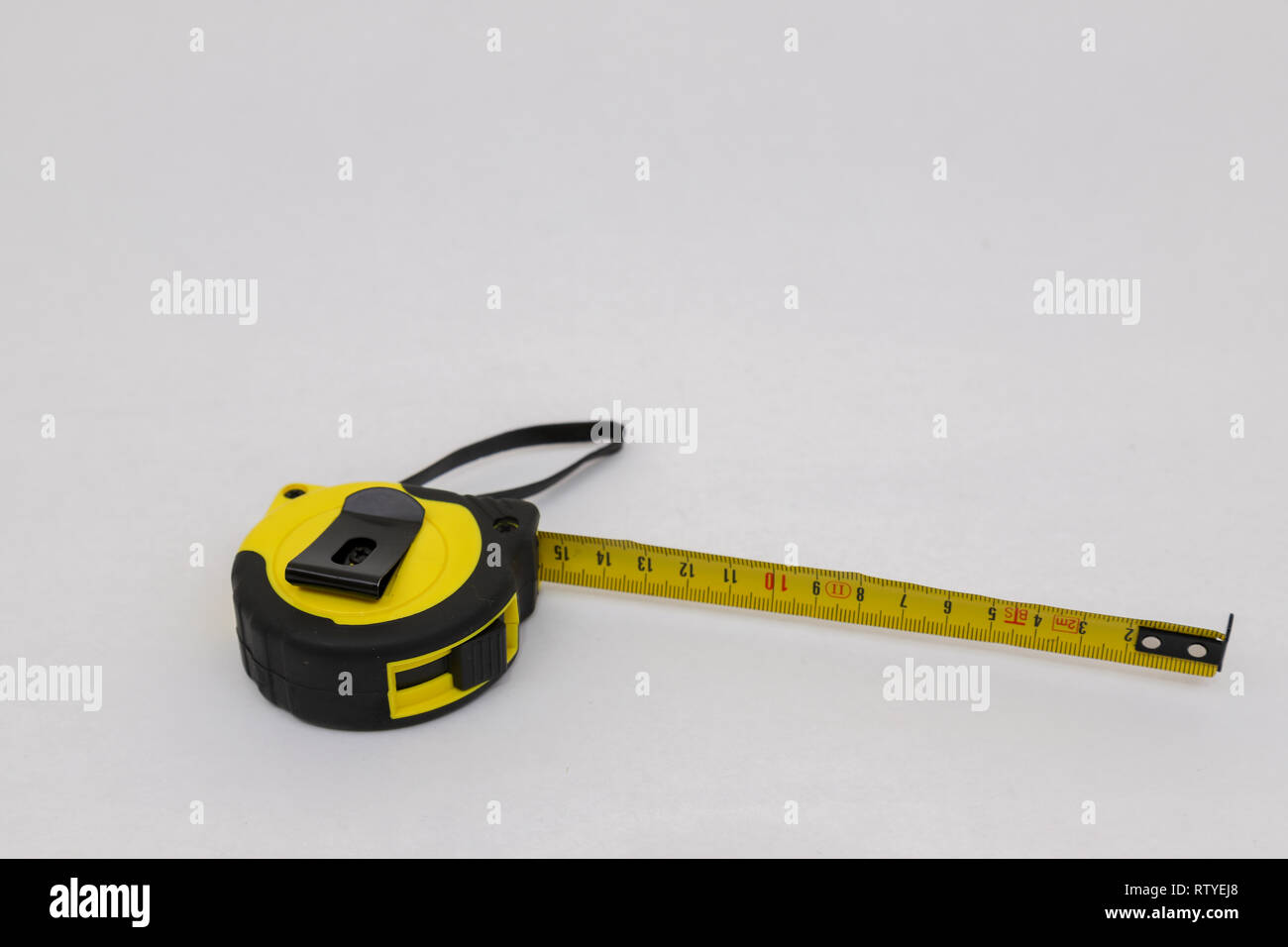Yellow tape measure, measuring Stock Photo - Alamy