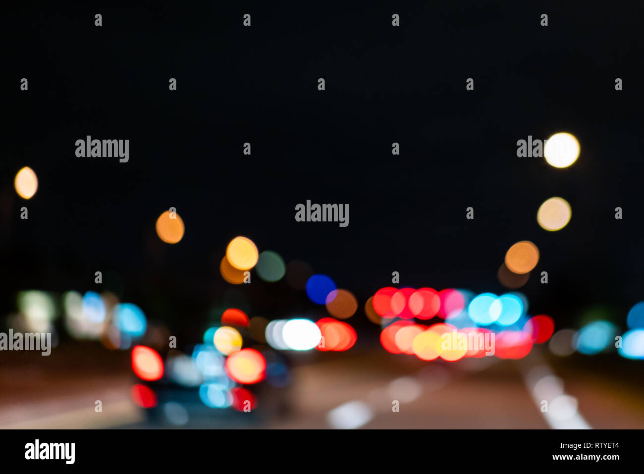 Colorful Blurred Lights out of focus picture of the street with cars at ...