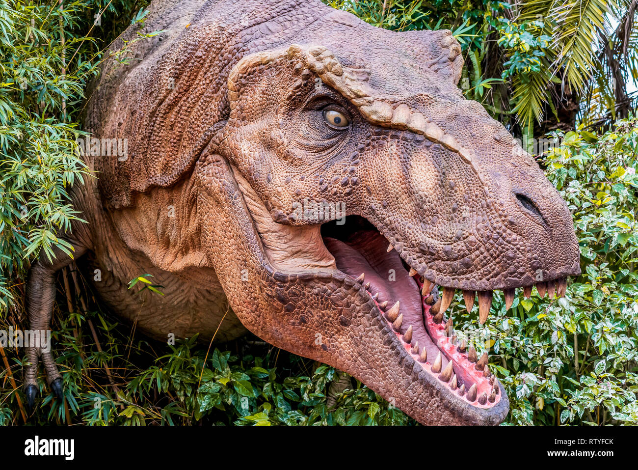 ORLANDO, FLORIDA, USA - DECEMBER, 2018: Dinosaur between the bushes ...