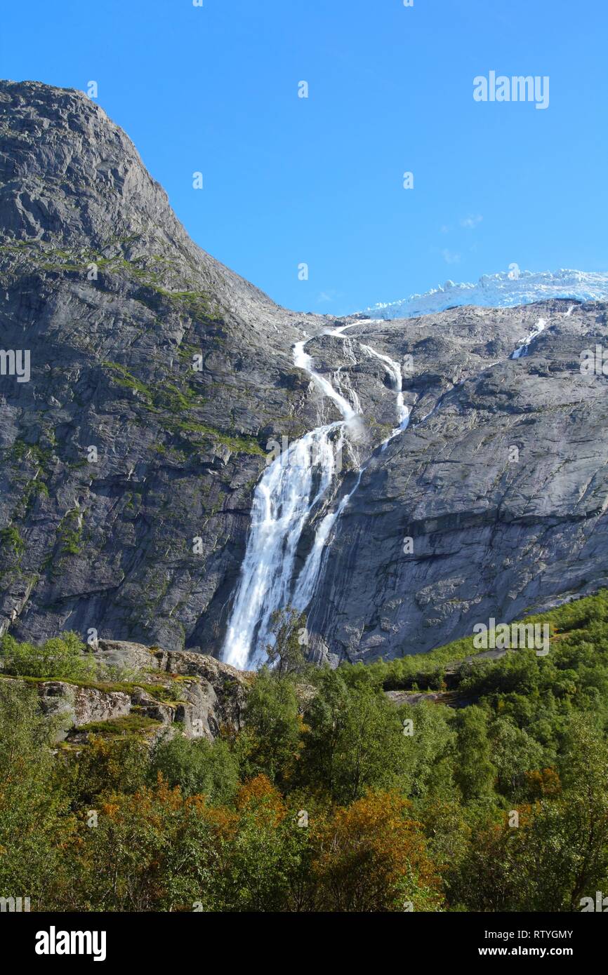 Norway, Jostedalsbreen National Park. Waterfall originating from ...
