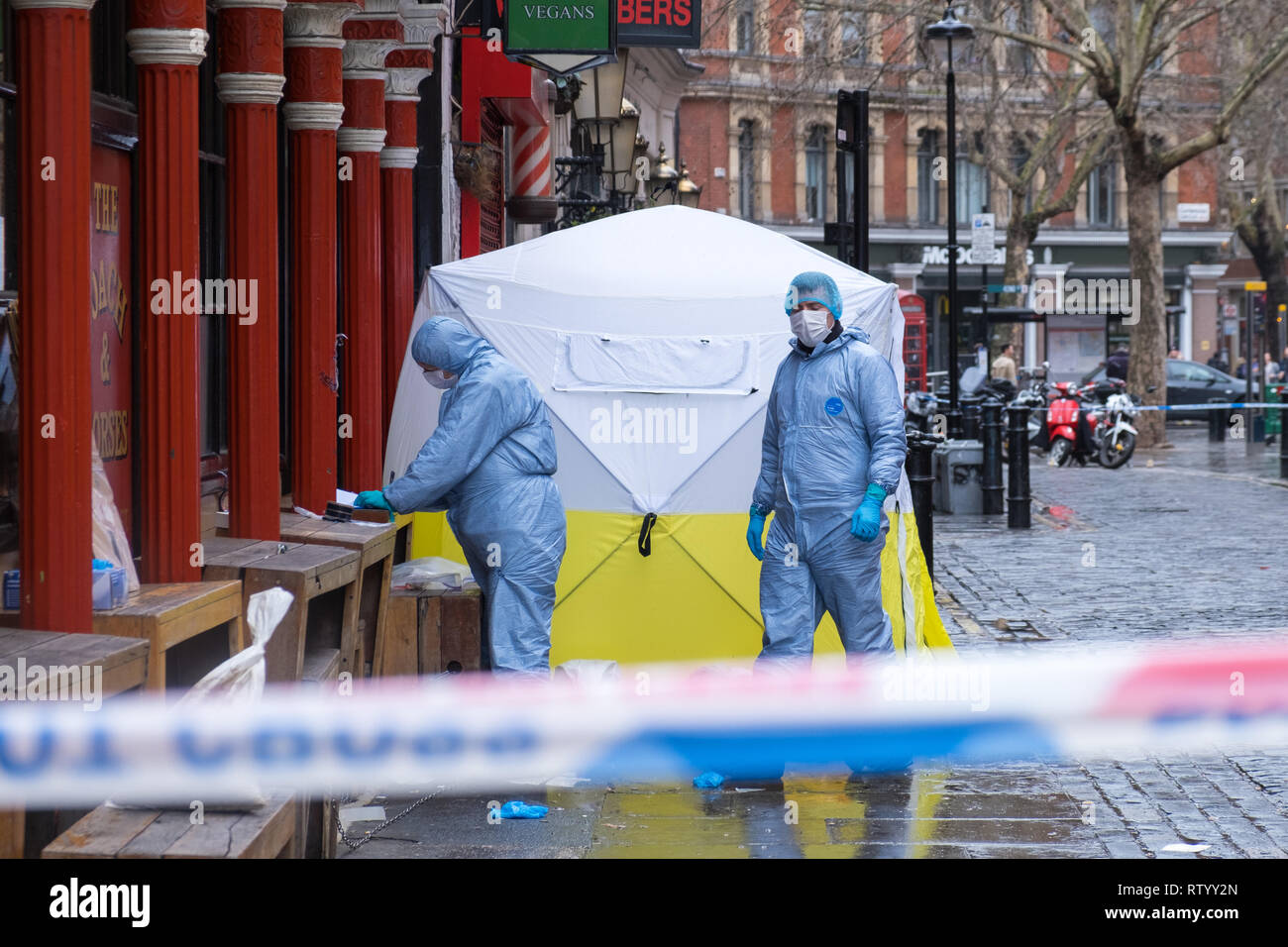 Soho, London, UK - March 3, 2019: Forensic officers at the crime scene ...