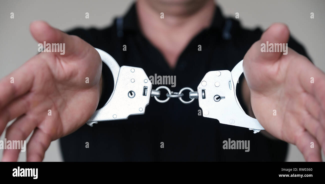 The man at the police station. Handcuffs on the wrists of the detained ...
