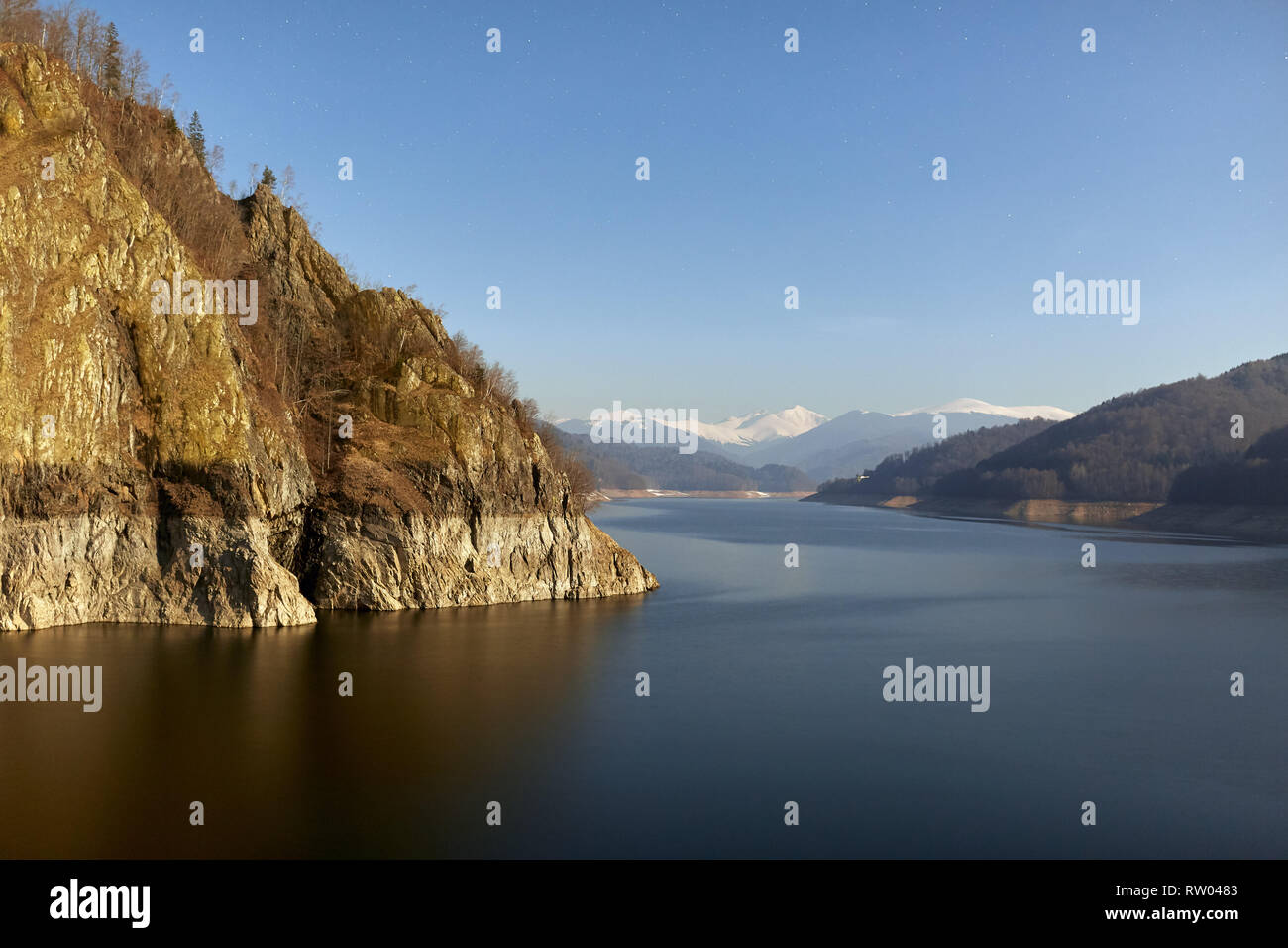 Landscape with dam lake between mountains Stock Photo - Alamy