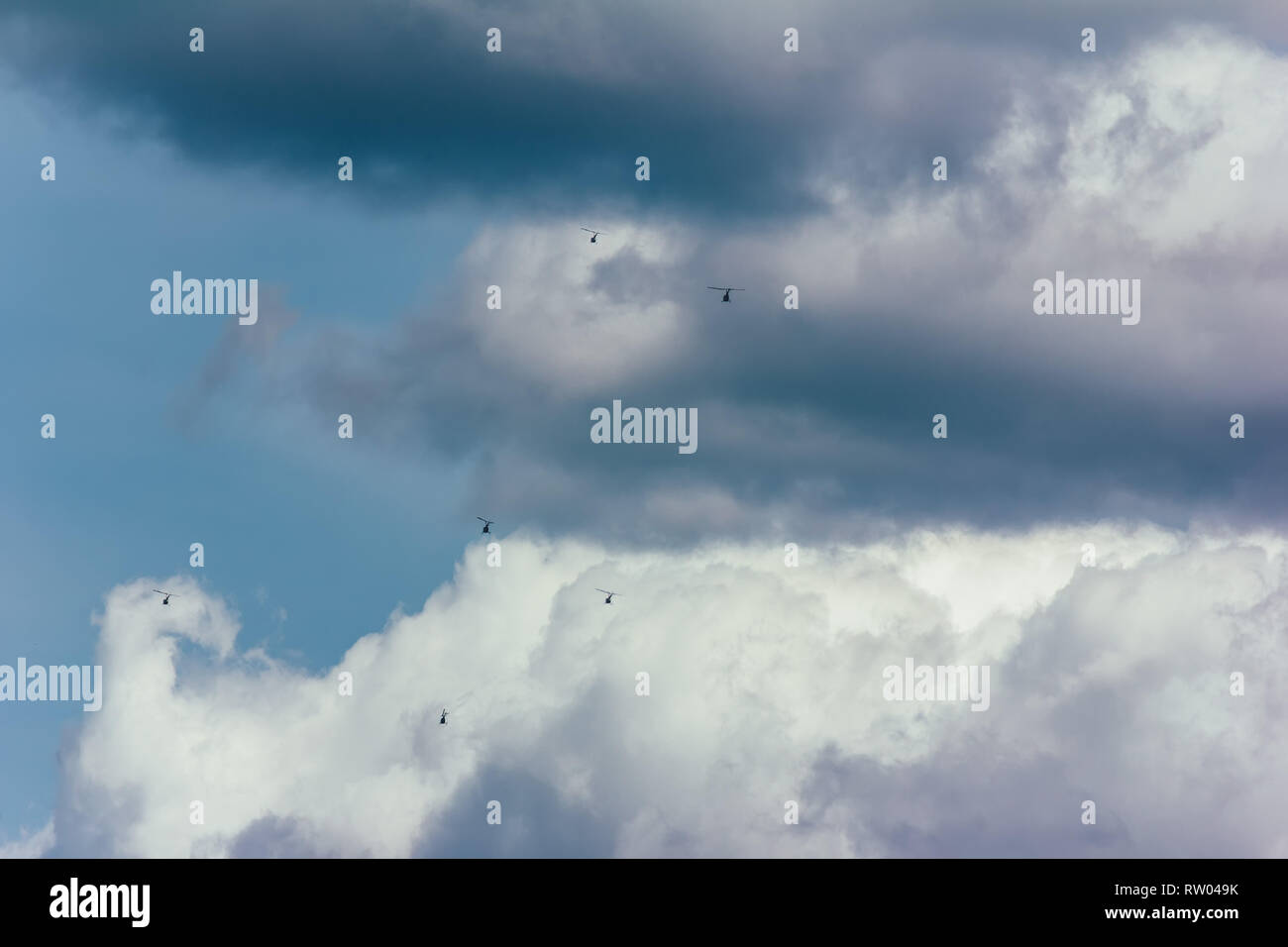 landscape with cloudy sky and helicopters flying in the distance Stock ...