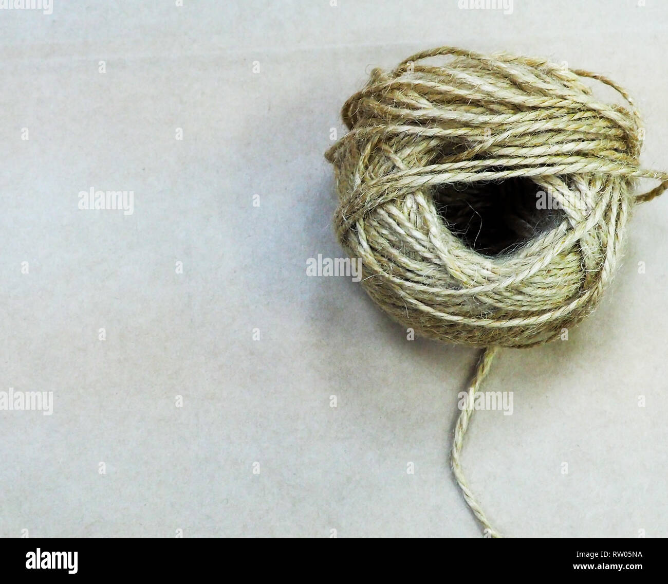 Natural Jute Twine Roll, top view on white wood background. DIY Wrap ...