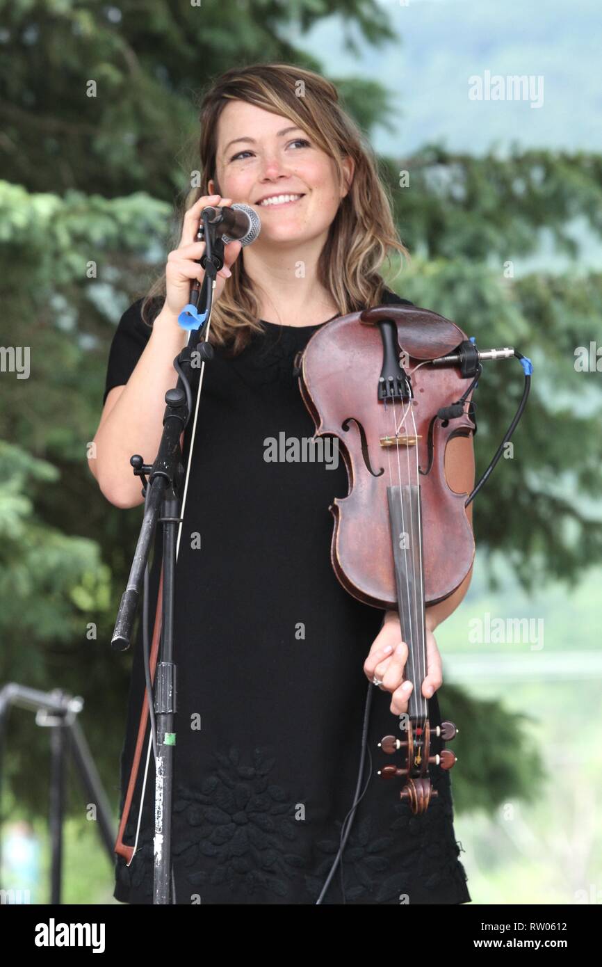 Musician Sara Watkins is shown performing on stage during a "live ...