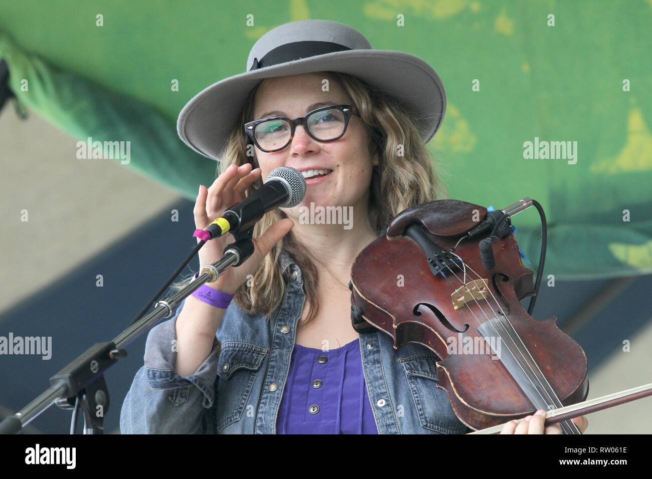 Musician Sara Watkins is shown performing on stage during a "live ...