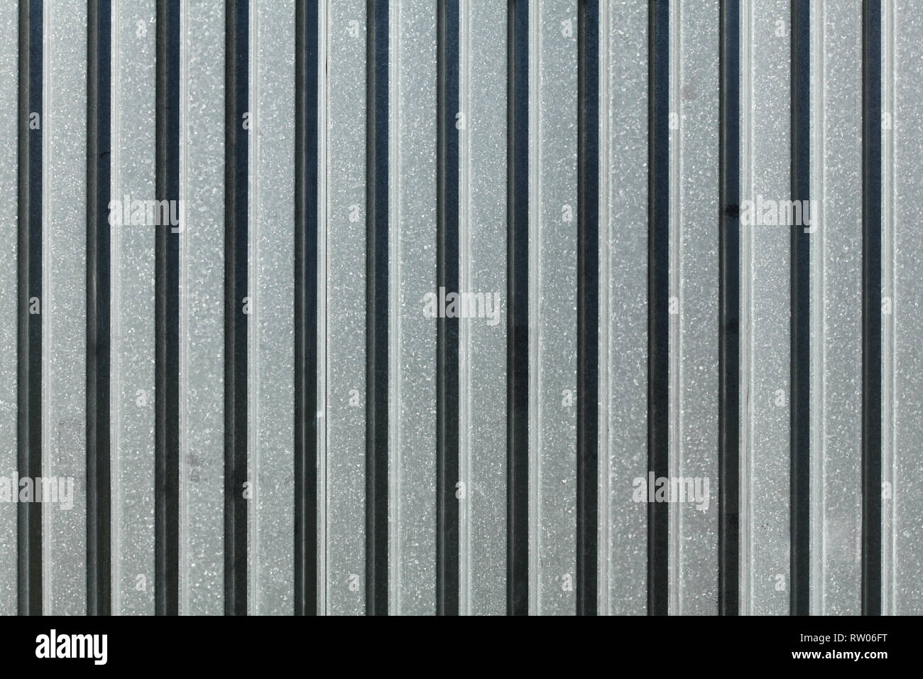 Metal plate fence, sun shining from side. Abstract construction ...
