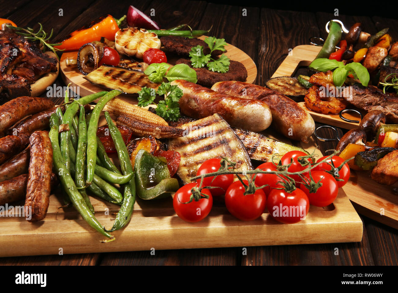 Assorted delicious grilled meat with vegetable and herbs on rustic ...