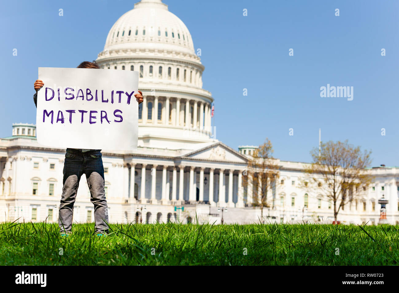 Child boy protest in front of the USA capitol in Washington holding ...